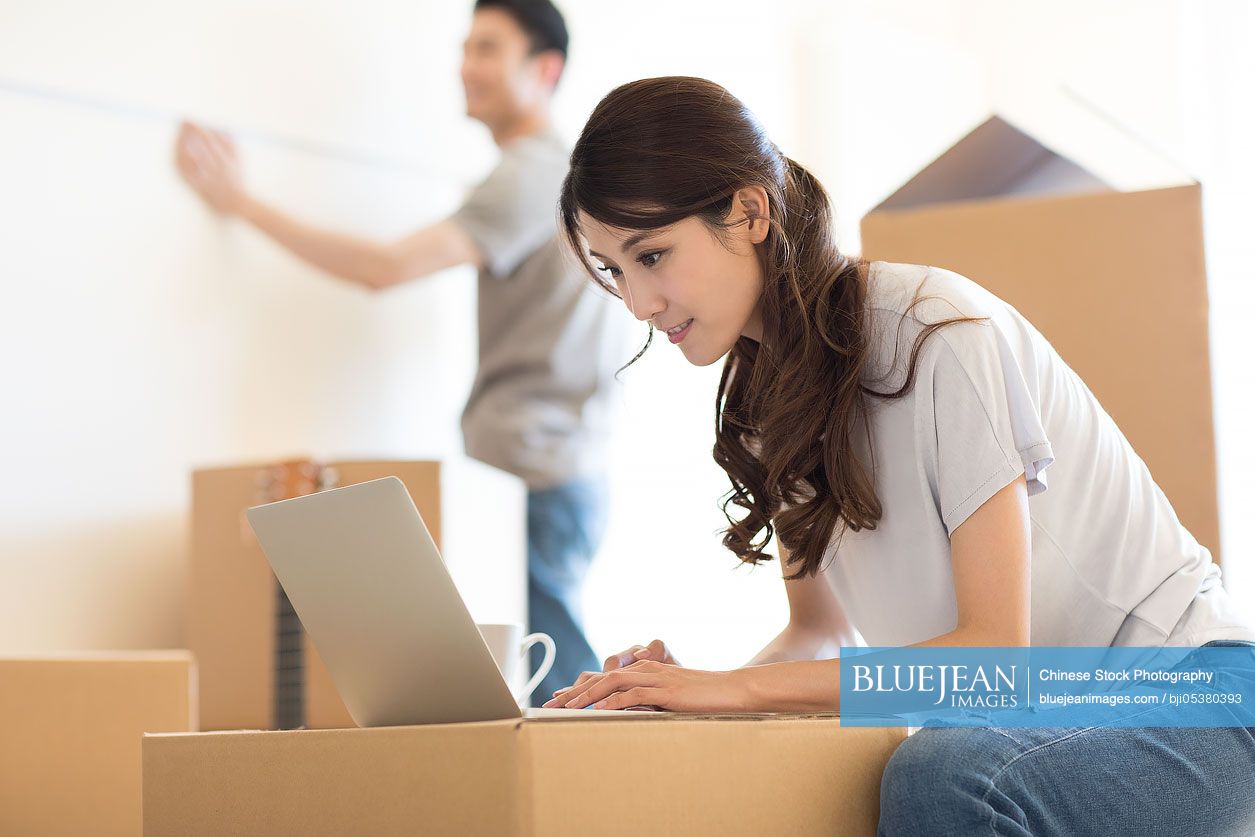 Happy young Chinese couple moving to a new house-High-res stock photo ...