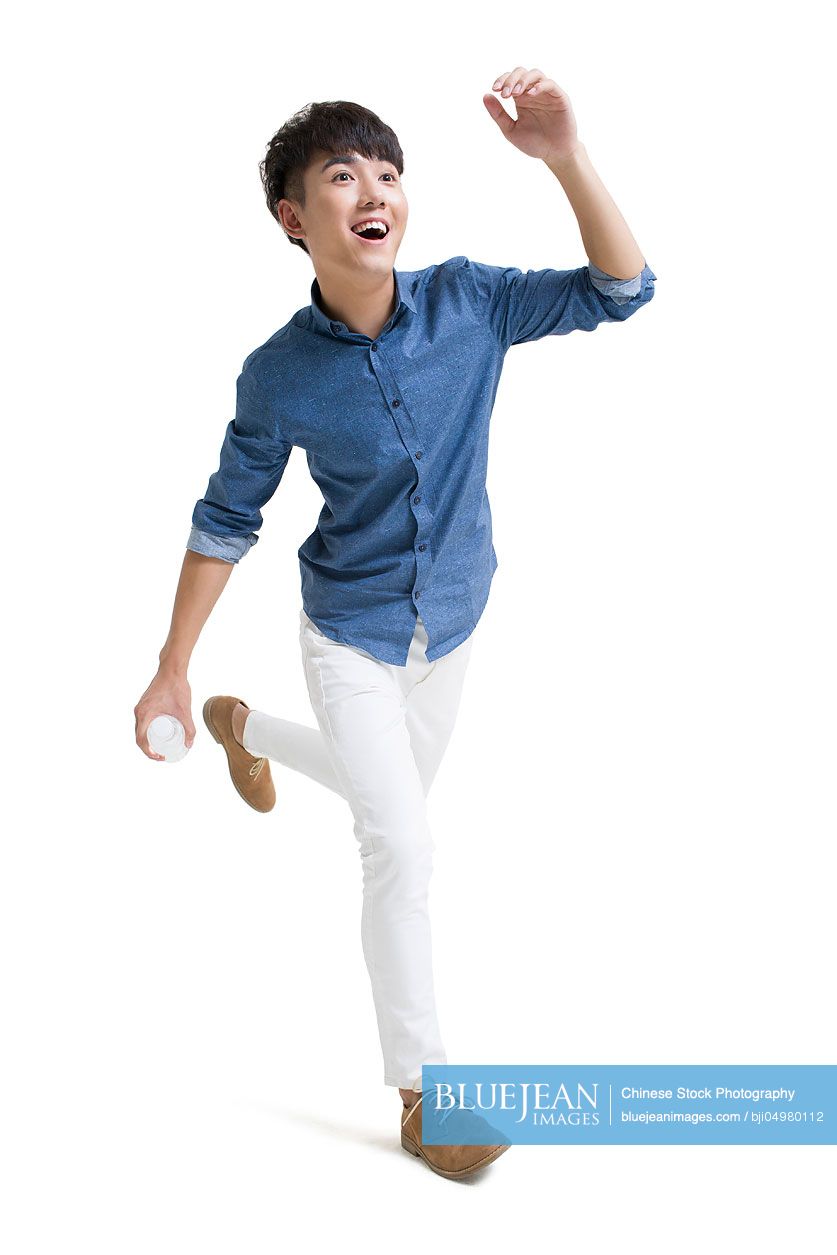 Happy young Chinese man running with a bottle of water-High-res stock ...