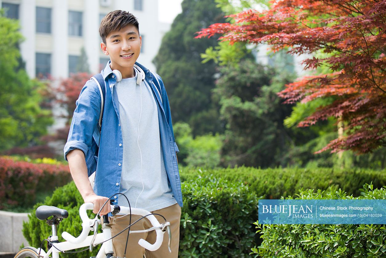Male Chinese college student with bicycle-High-res stock photo for download