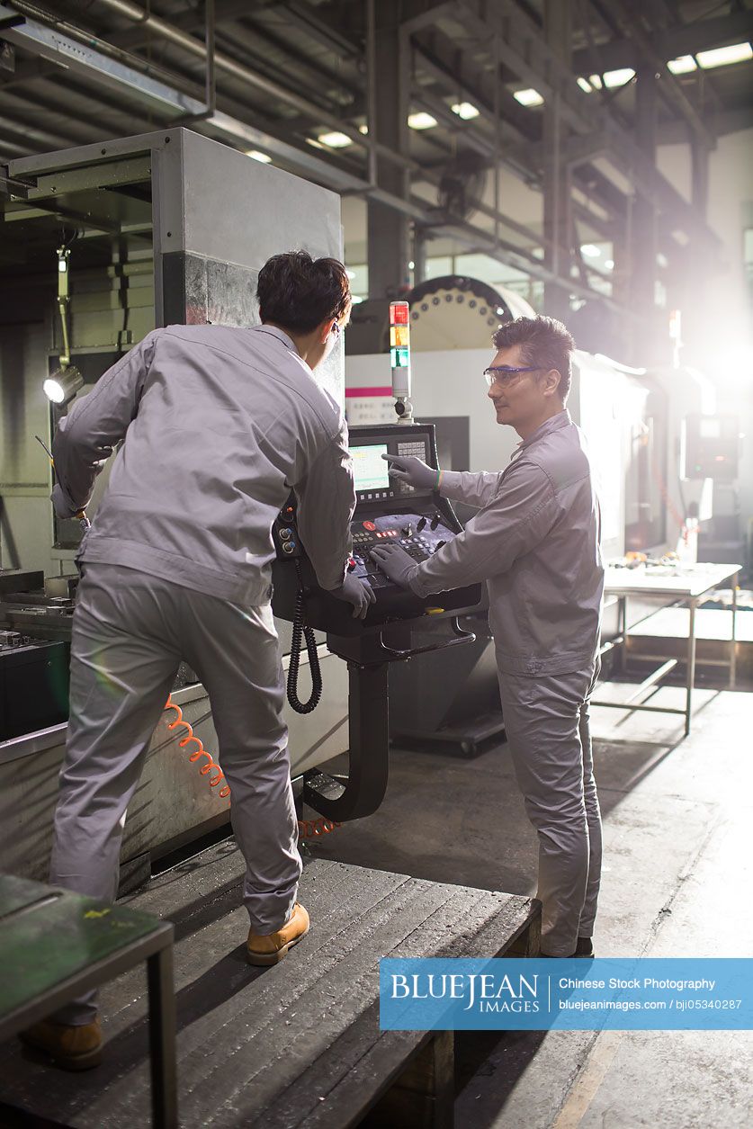 Confident Chinese engineers working in the factory-High-res stock photo ...