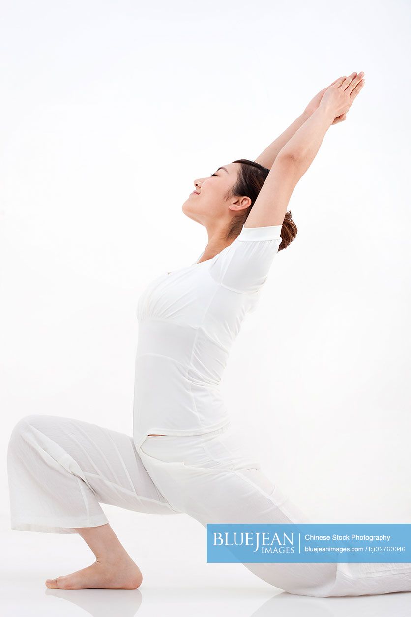 Young Chinese woman stretching and practicing yoga-High-res stock photo ...