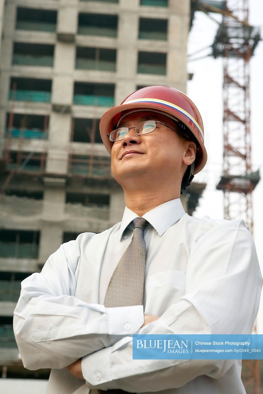 Chinese Construction Contractor Looking Up At Building-High-res stock ...