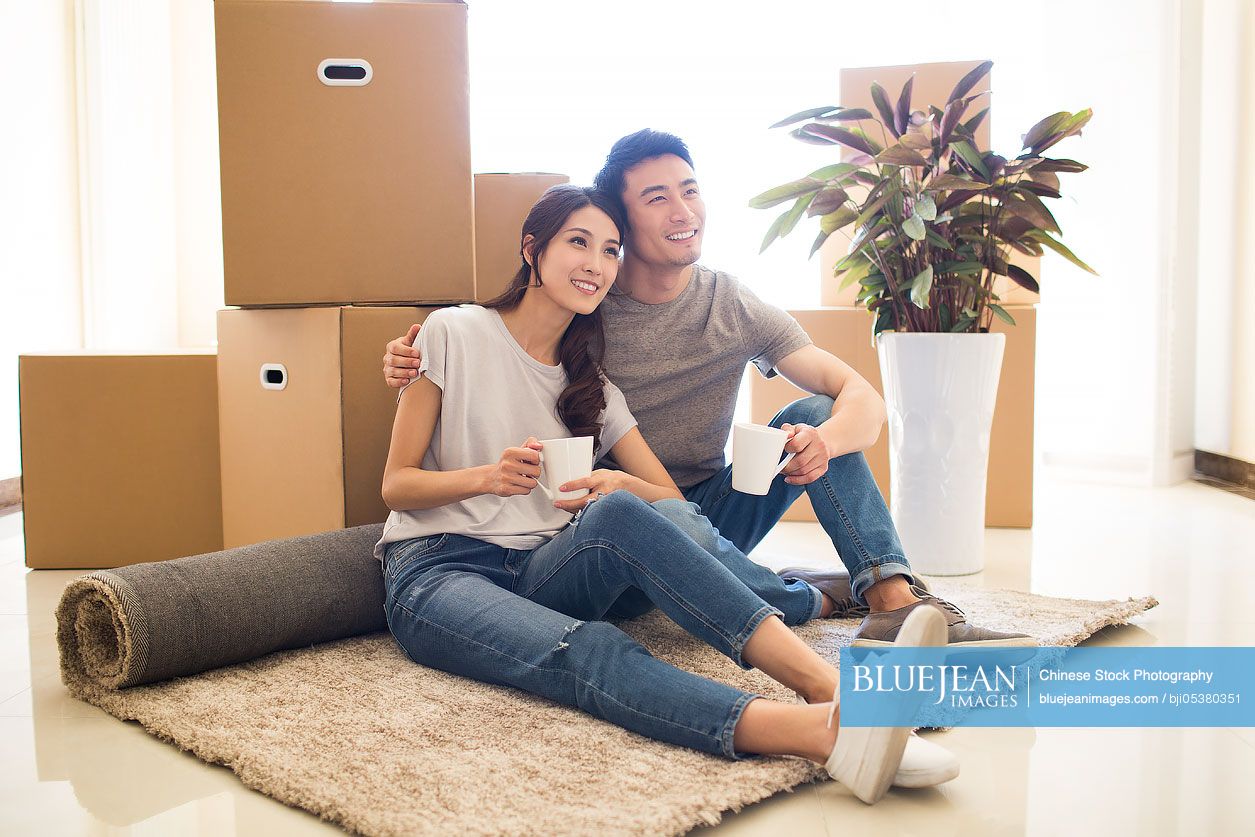 Happy young Chinese couple moving to a new house-High-res stock photo ...