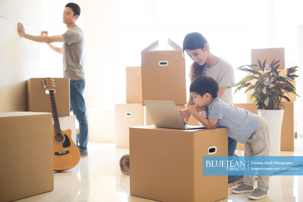 Happy young Chinese family moving to a new house-High-res stock photo ...