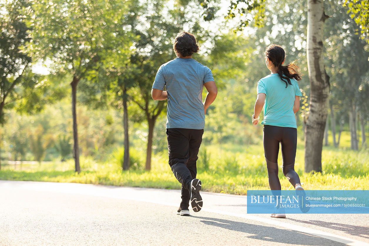 Happy mature Chinese couple running in park-High-res stock photo for download