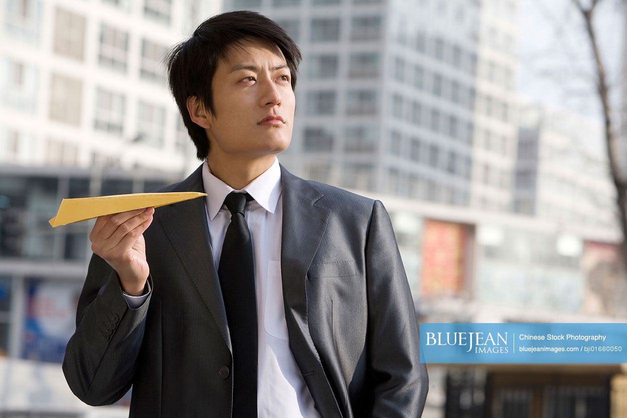 Chinese businessman throwing paper airplane-High-res stock photo for ...