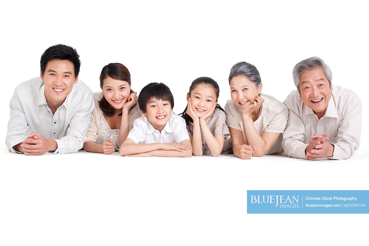 Happy Chinese family lying on front, studio shot-High-res stock photo ...
