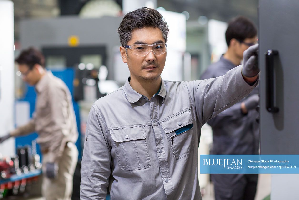 Confident Chinese engineers working in the factory-High-res stock photo ...