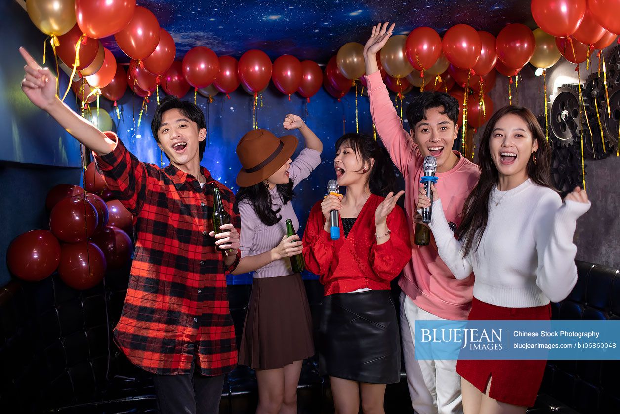 Happy young Chinese friends singing karaoke in nightclub-High-res stock ...