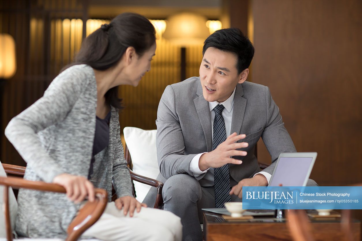 Confident Chinese businessman talking with a mature woman-High-res ...