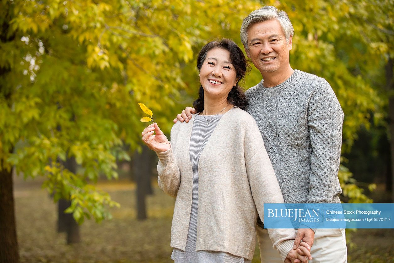 Happy senior Chinese couple dating in woods-High-res stock photo for download