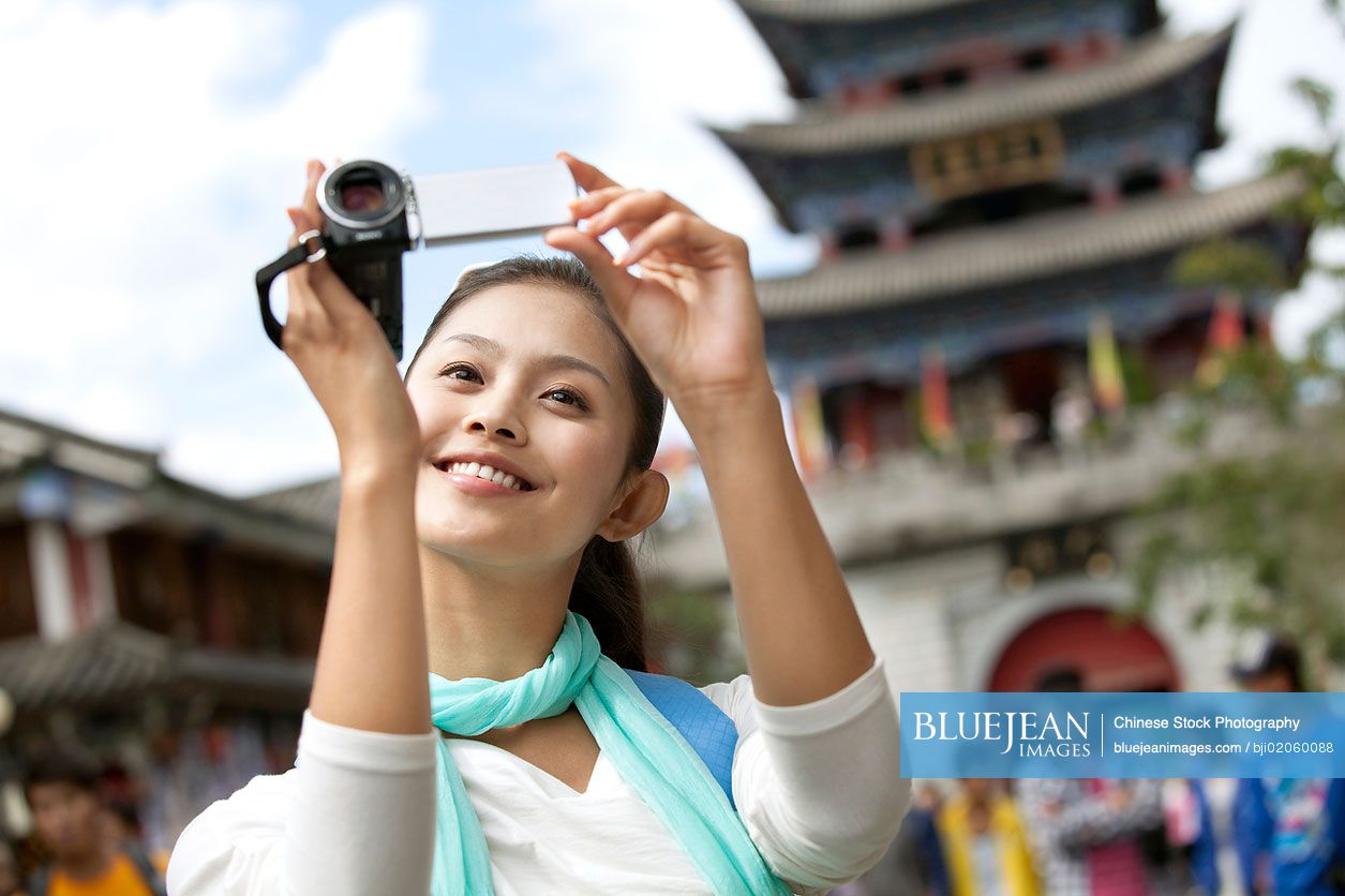 Young Chinese woman exploring Dali with digital video camera-High-res ...