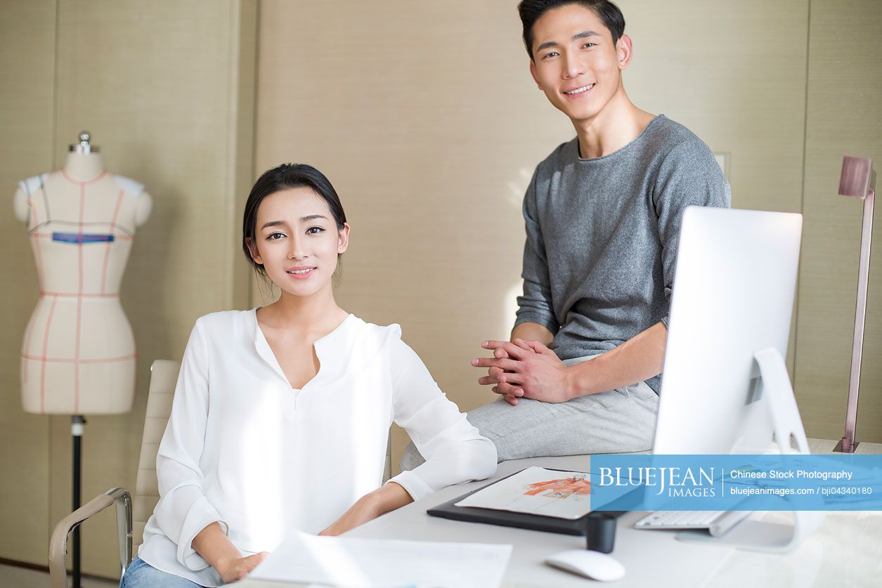 Young Chinese couple designing clothing together-High-res stock photo for download