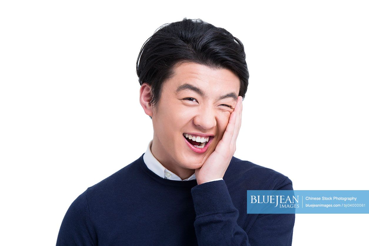 Cheerful young Chinese man laughing-High-res stock photo for download
