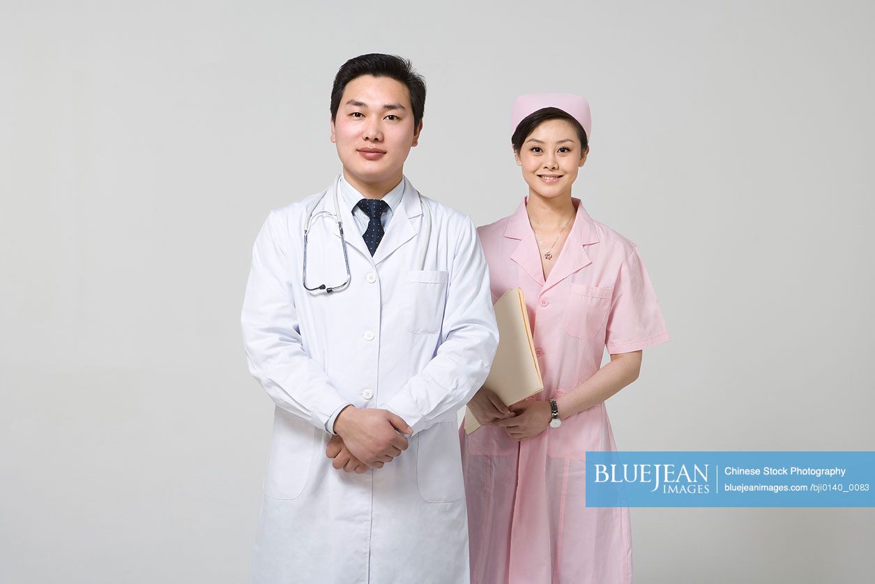 Chinese doctor with nurse in pink uniform-High-res stock photo for download