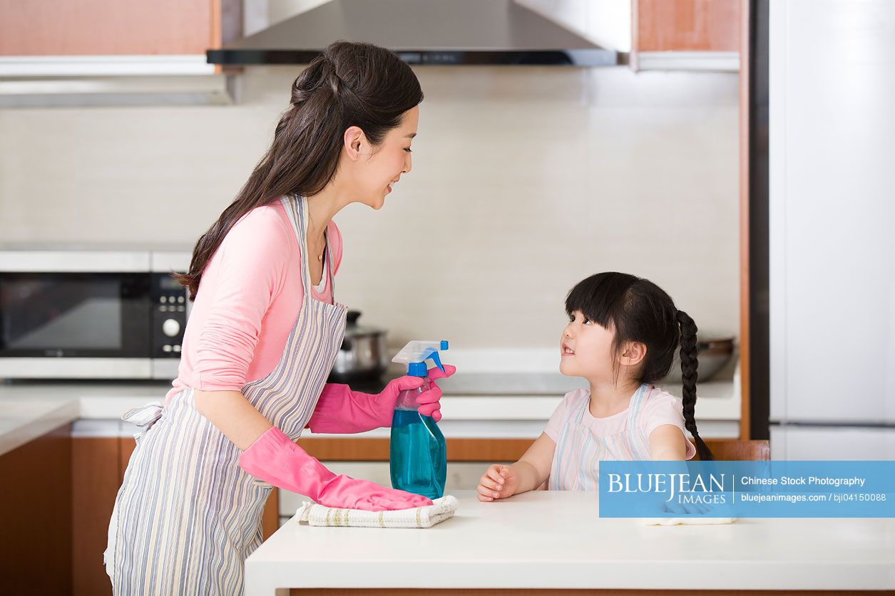 Chinese mother and daughter cleaning kitchen counter-High-res stock ...
