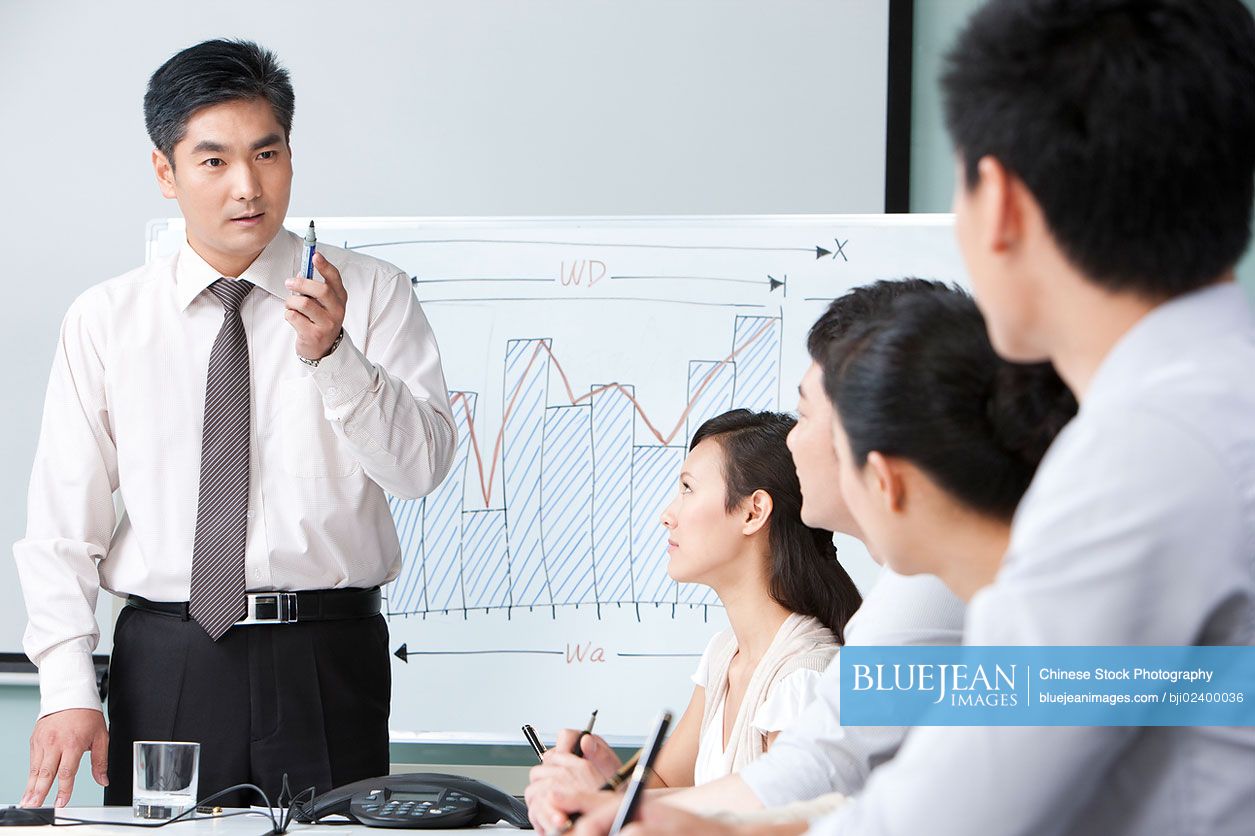 Chinese business executive presenting to business team-High-res stock ...