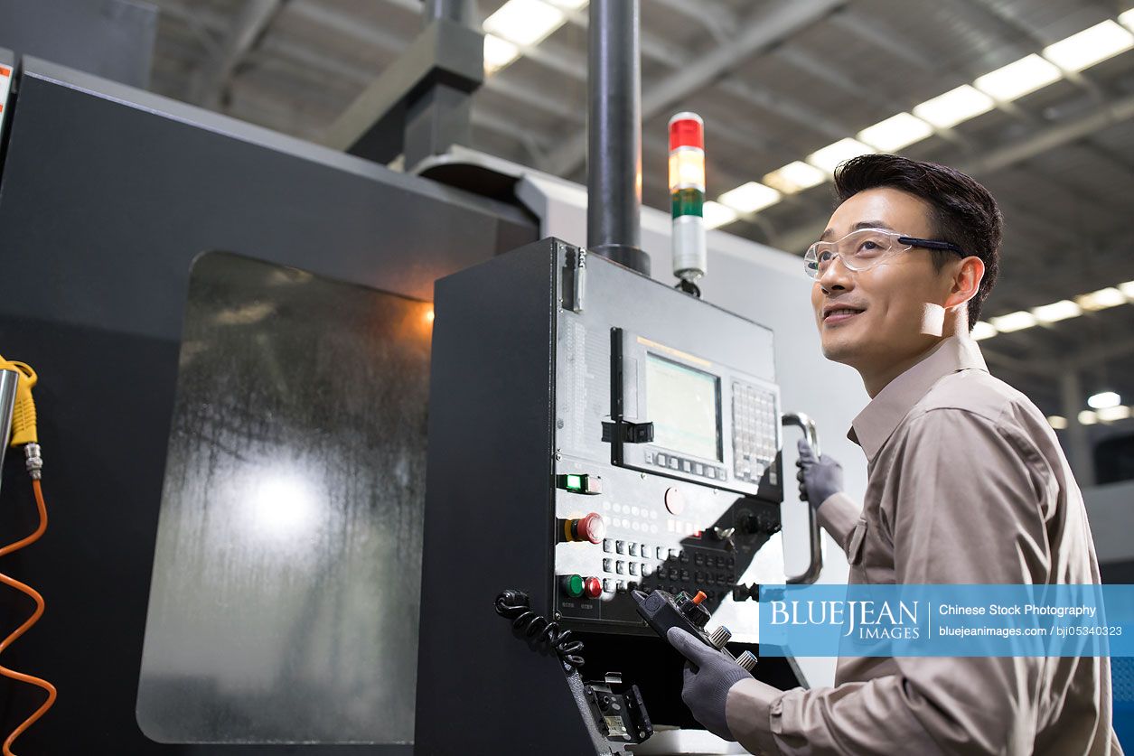 Confident Chinese engineer working in the factory-High-res stock photo ...