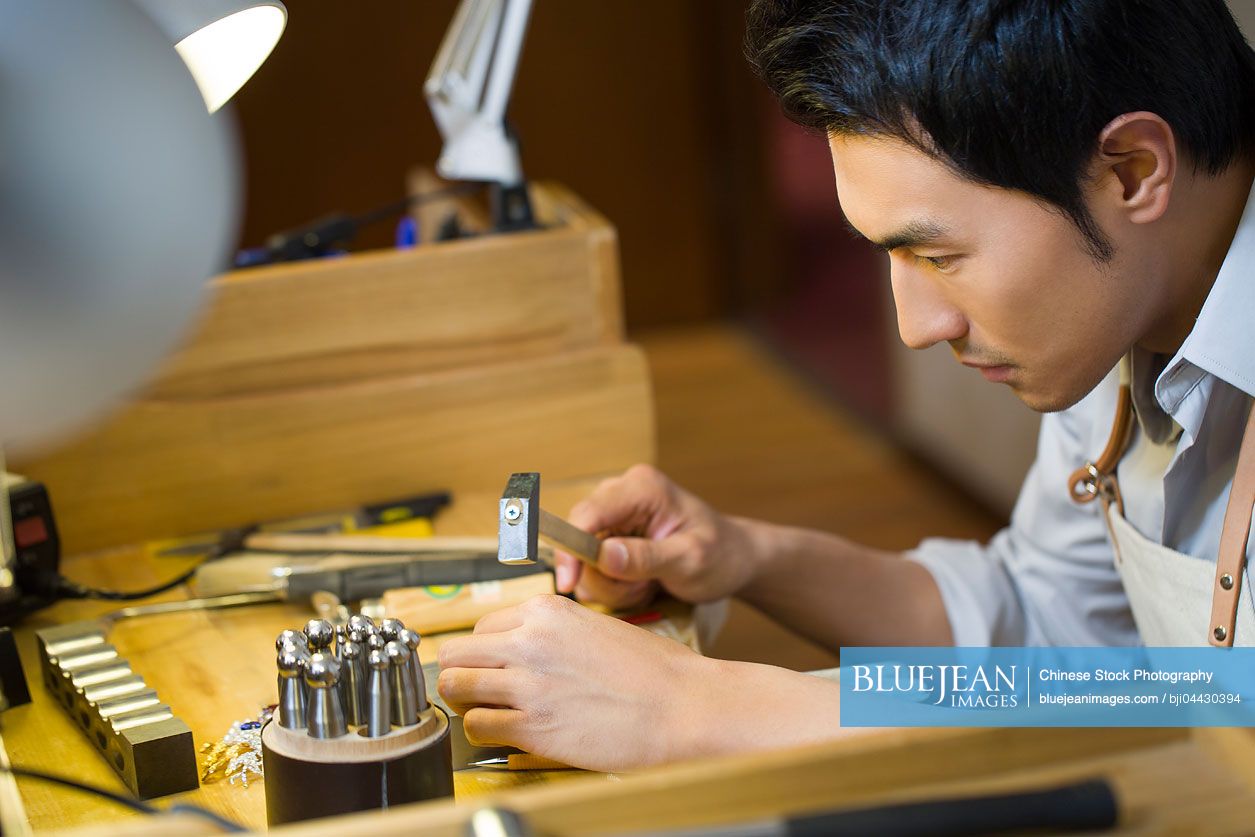 Chinese male jeweler working in studio-High-res stock photo for download