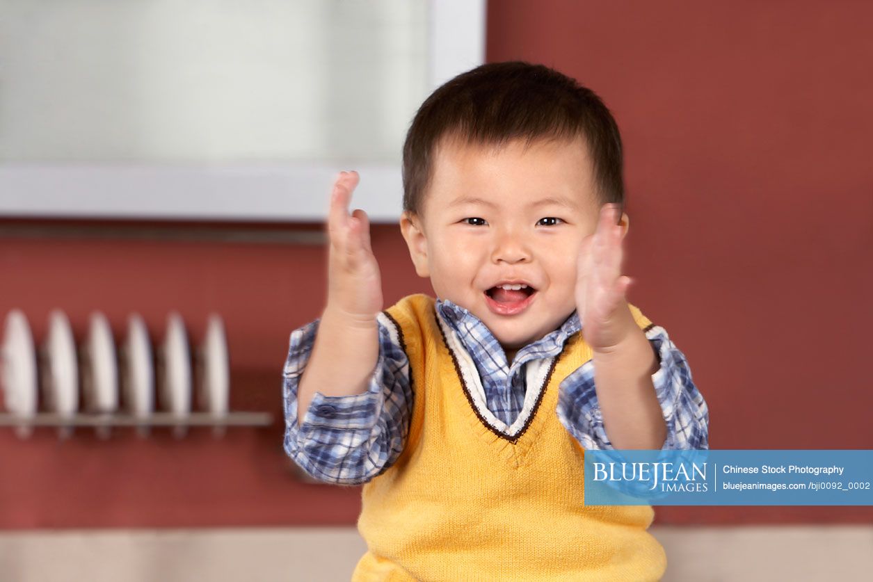 Young Chinese boy clapping happily-High-res stock photo for download