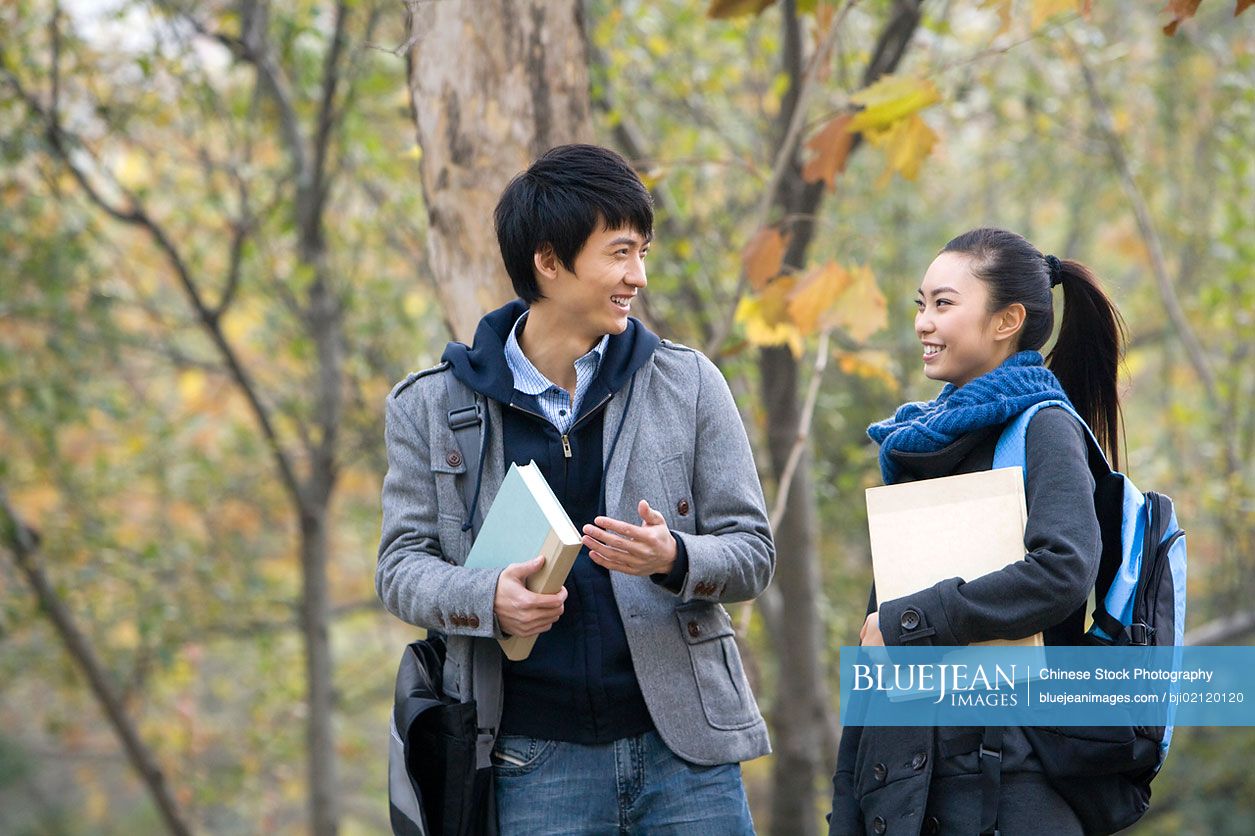 Young Chinese man and woman talking together on campus-High-res stock ...