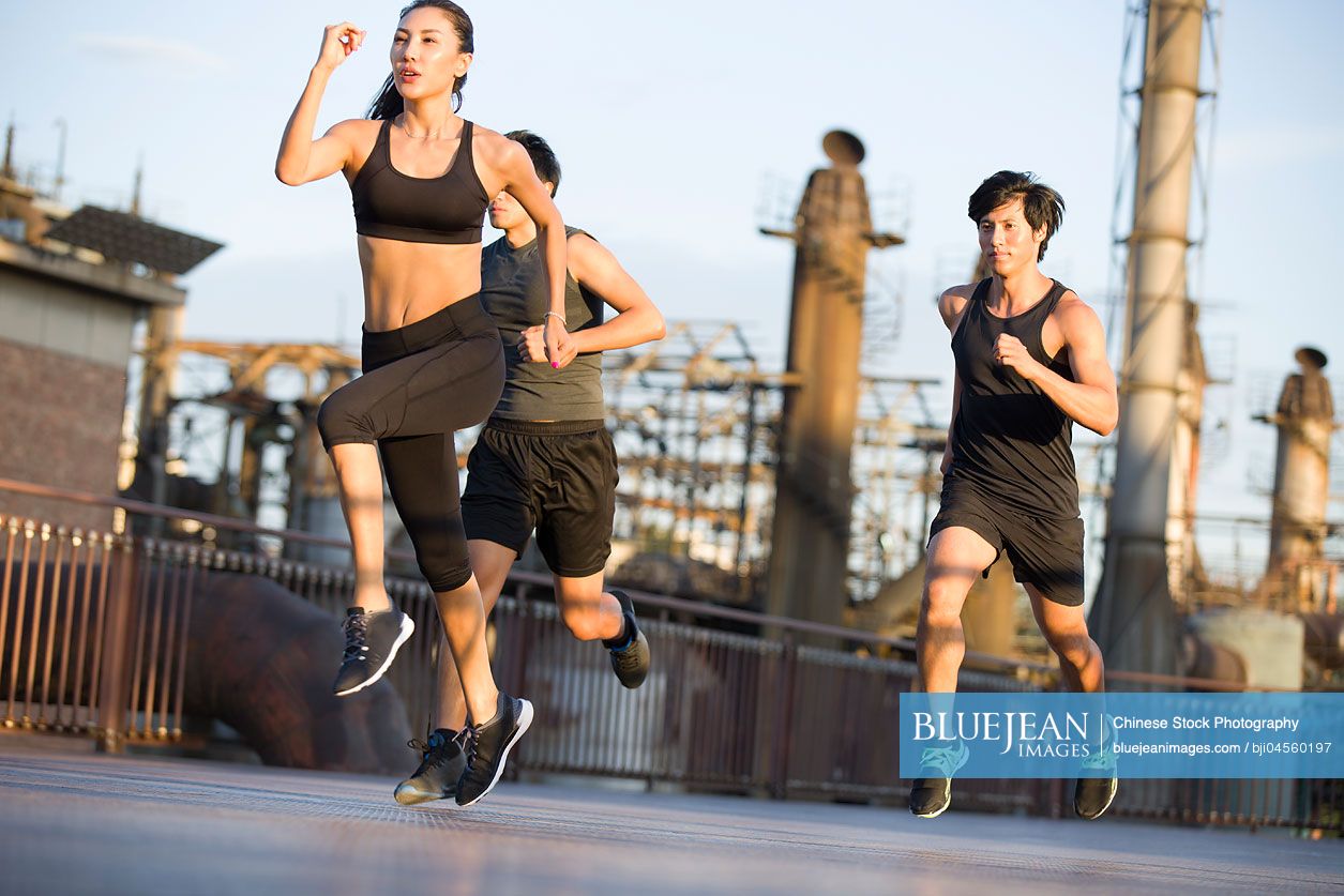Young Chinese joggers running outdoors-High-res stock photo for download
