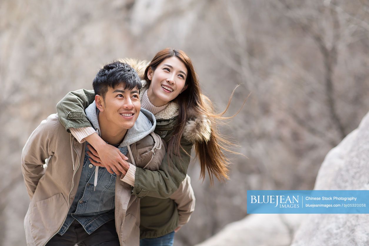 Happy young Chinese couple enjoying winter outing-High-res stock photo for download