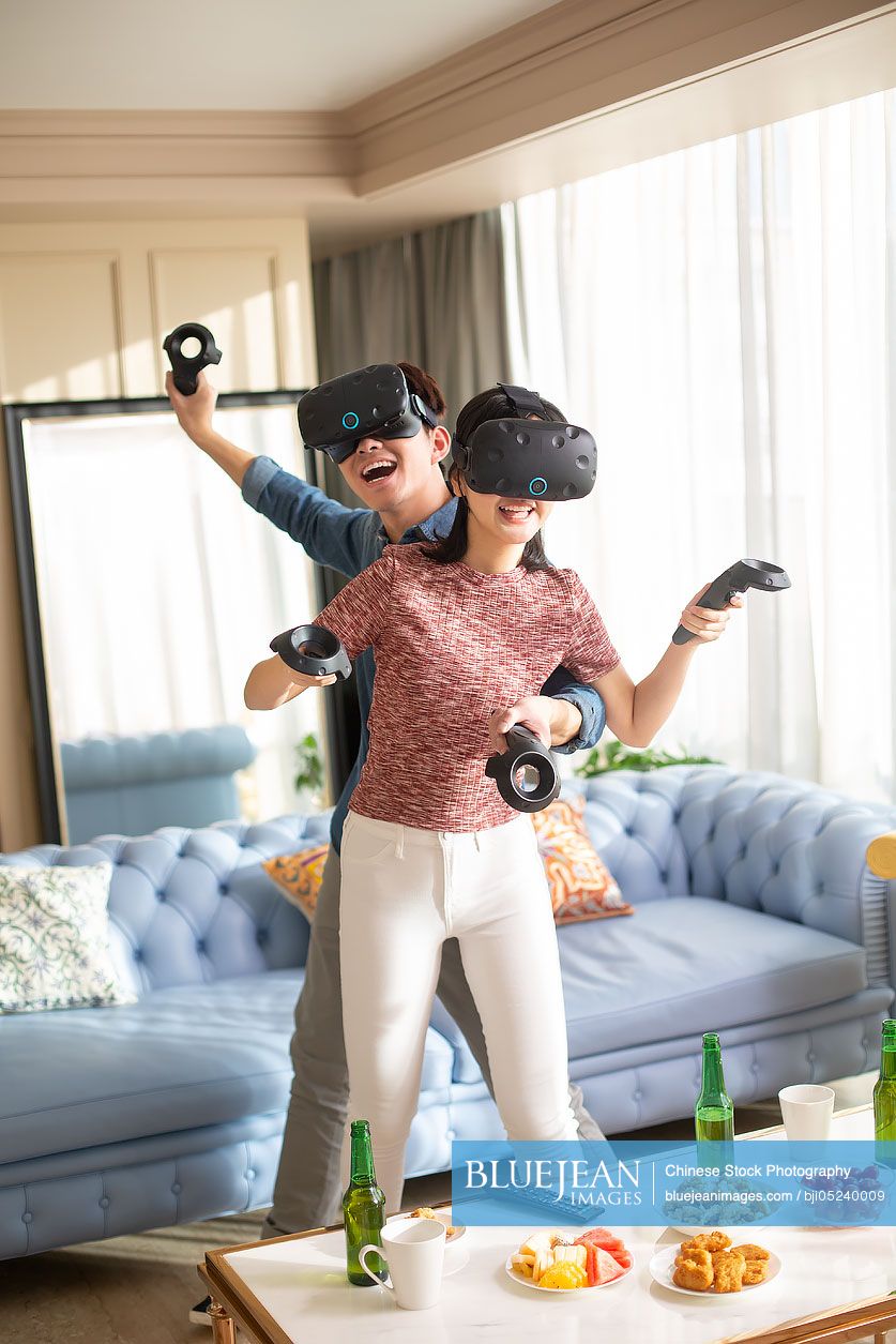 Young Chinese couple playing VR game-High-res stock photo for download