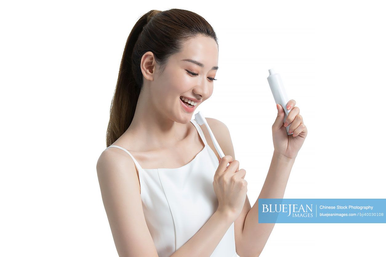 Beautiful young Chinese woman brushing teeth-High-res stock photo for ...