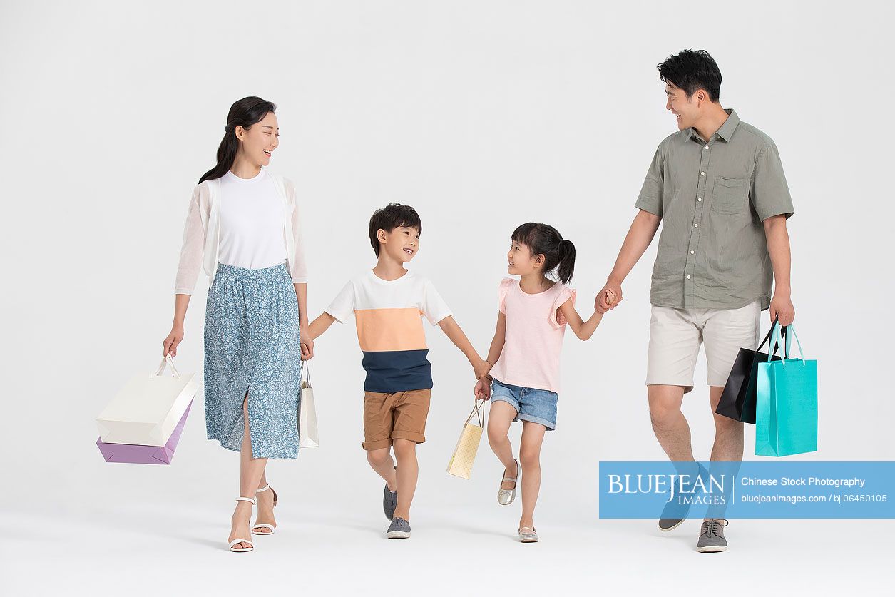 Happy young Chinese family shopping together-High-res stock photo for ...