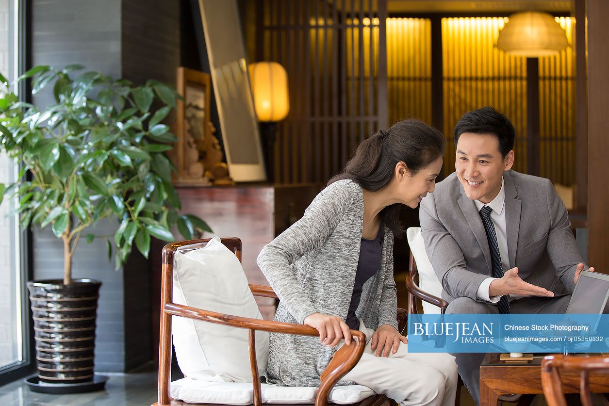 Confident Chinese financial consultant talking with a mature woman-High ...