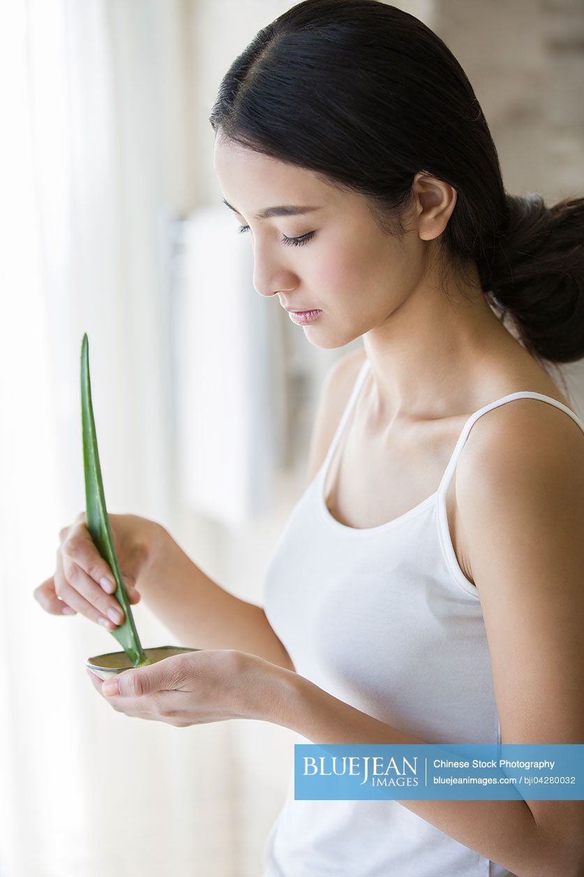 Young Chinese woman with natural aloe vera-High-res stock photo for download