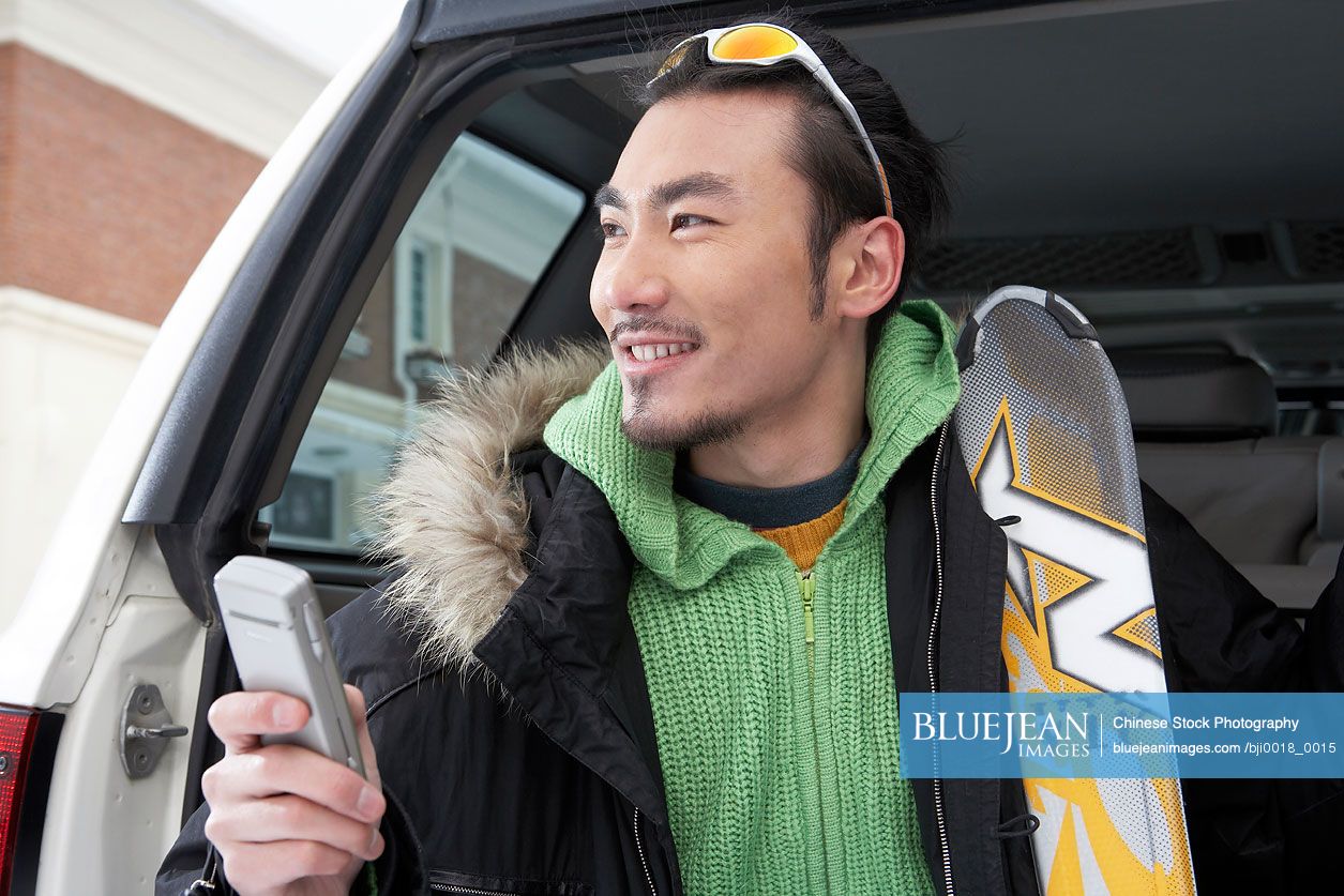 Chinese man texting on cell phone, looking into distance-High-res stock ...