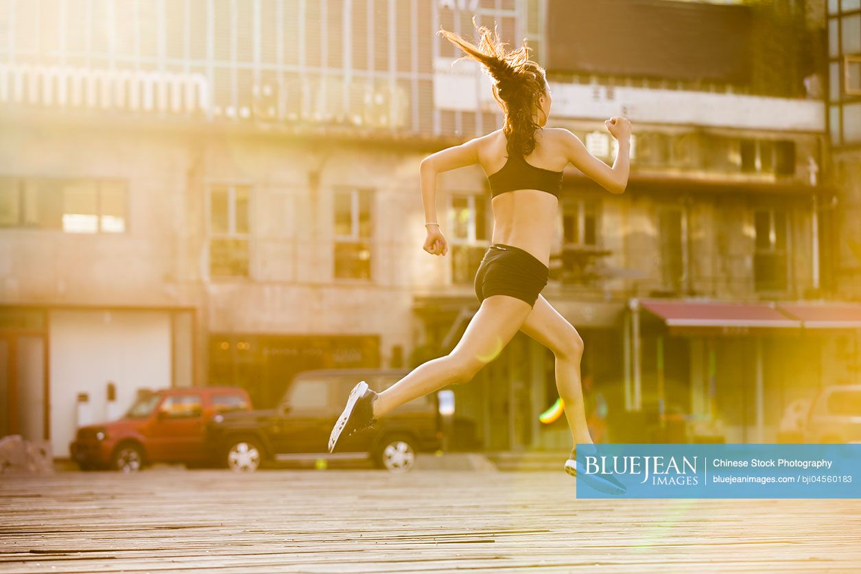 Young Chinese jogger running outdoors-High-res stock photo for download
