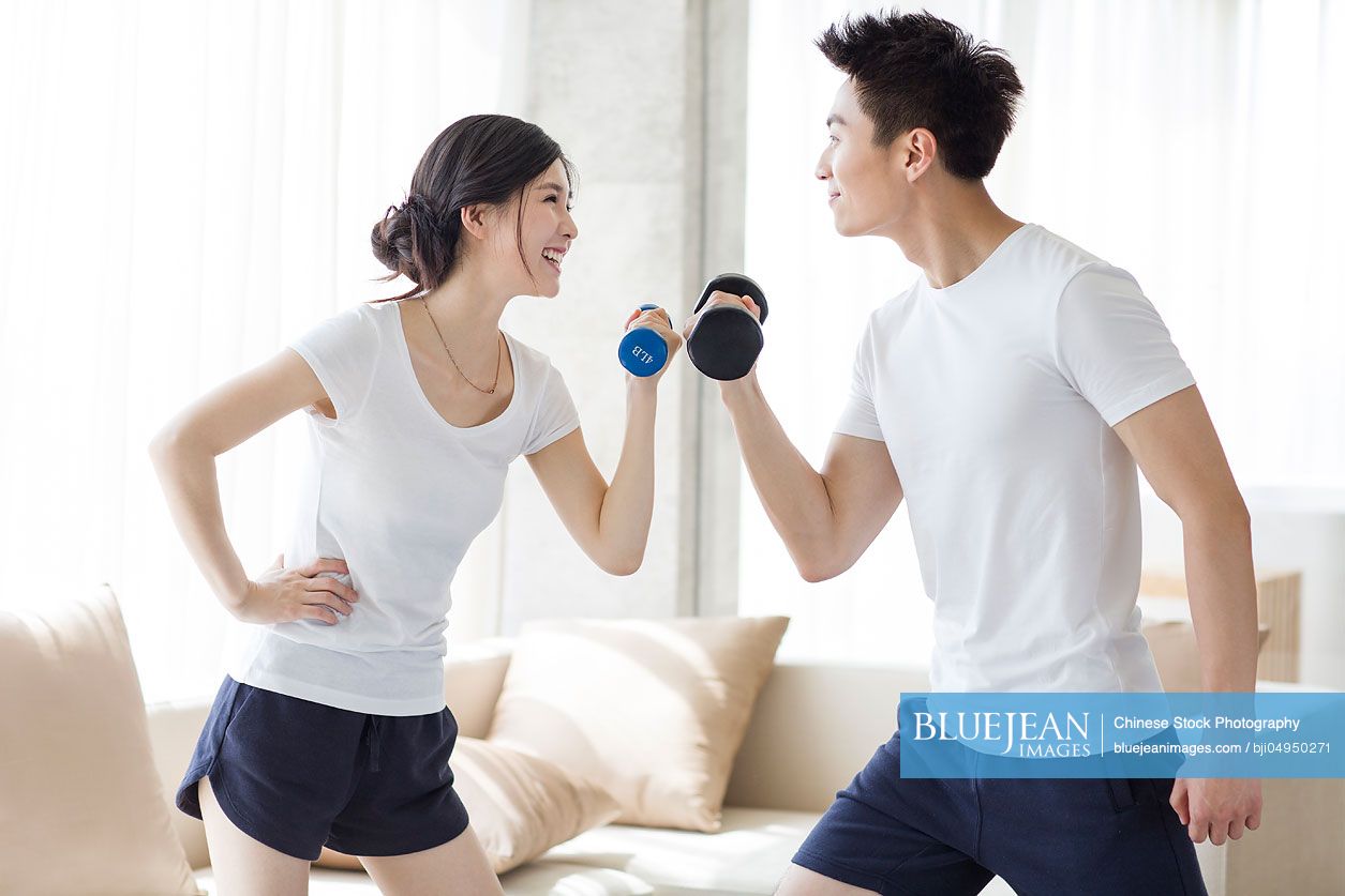 Young Chinese couple exercising at home-High-res stock photo for download