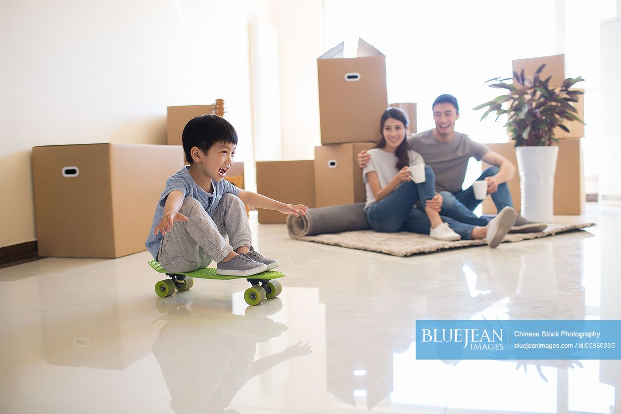 Happy young Chinese family moving to a new house-High-res stock photo ...