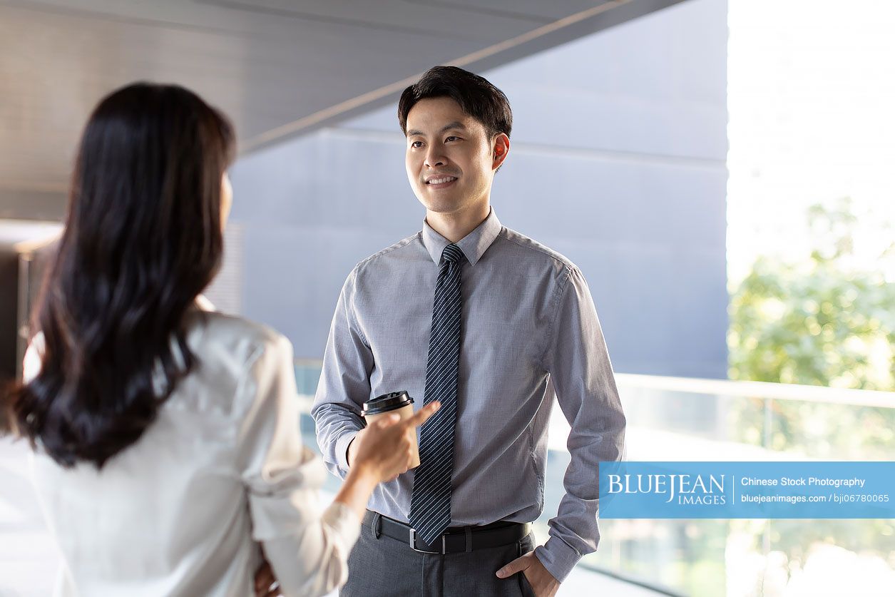 Confident Chinese business people talking-High-res stock photo for download