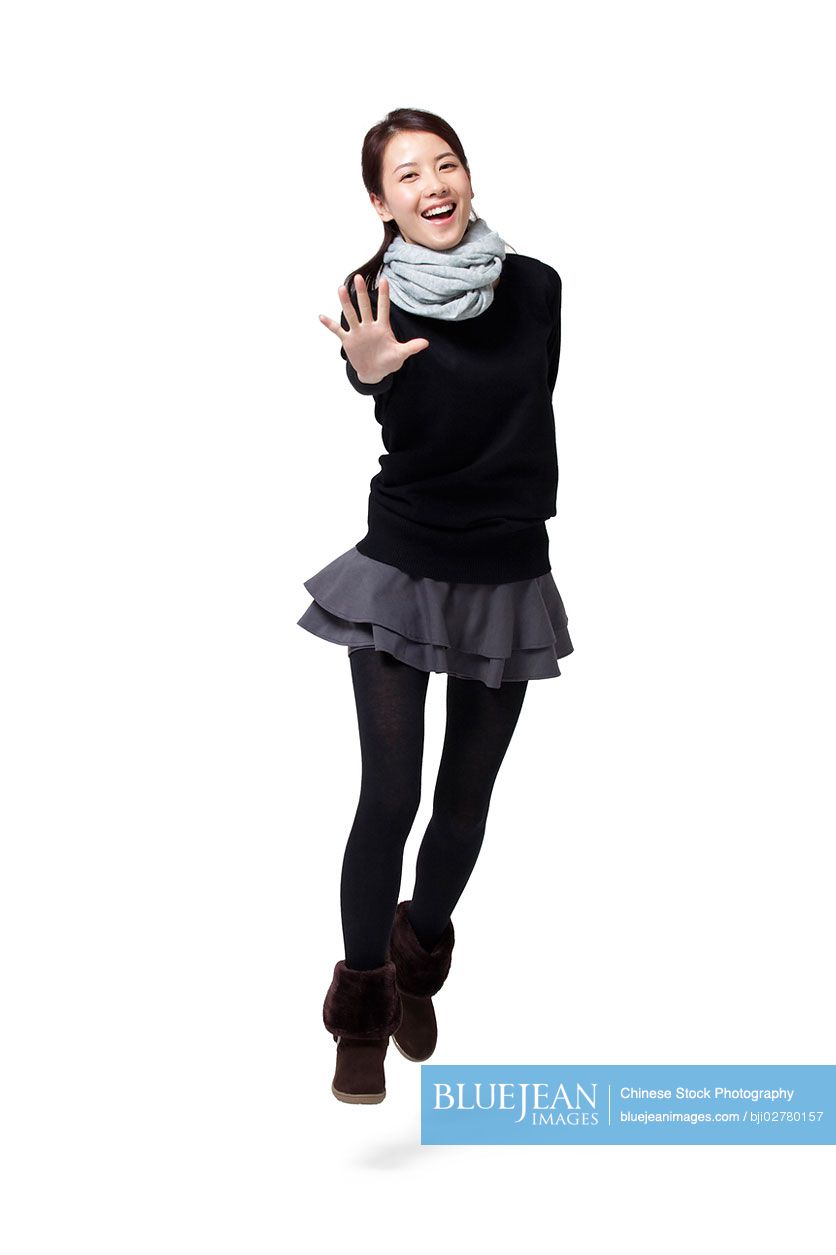 Young Chinese woman jumping in mid-air-High-res stock photo for download