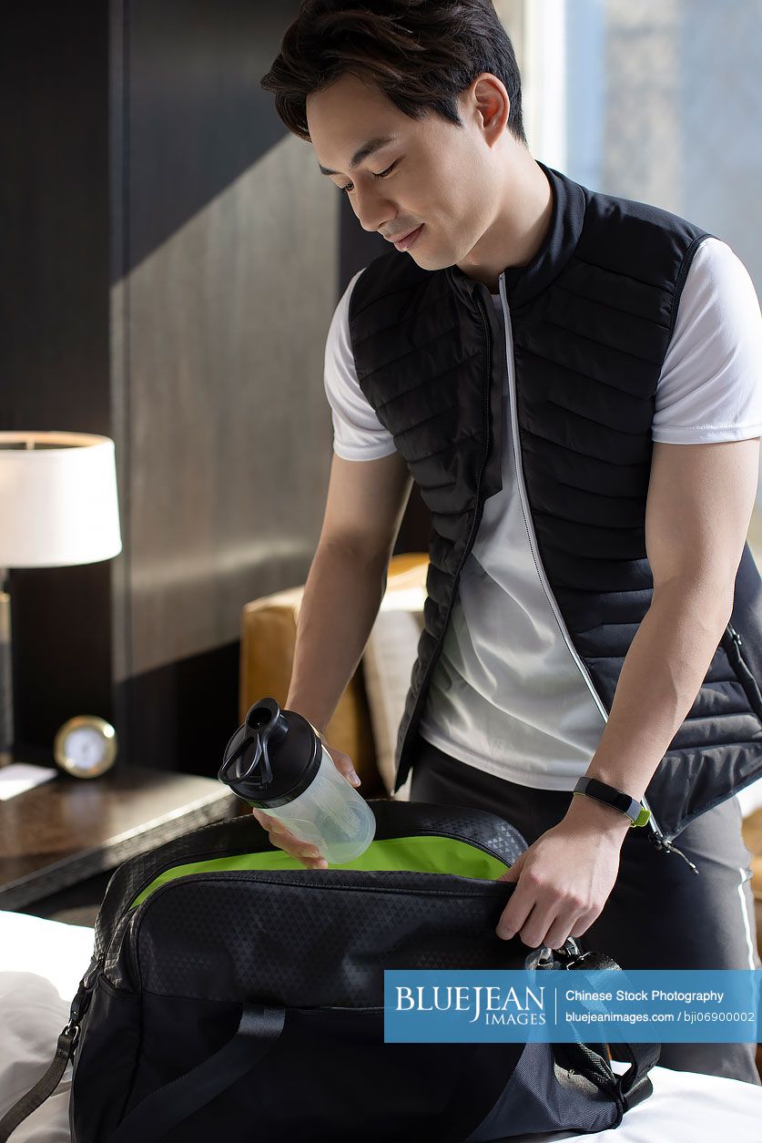 Chinese mid adult man getting ready to go out and workout-High-res ...