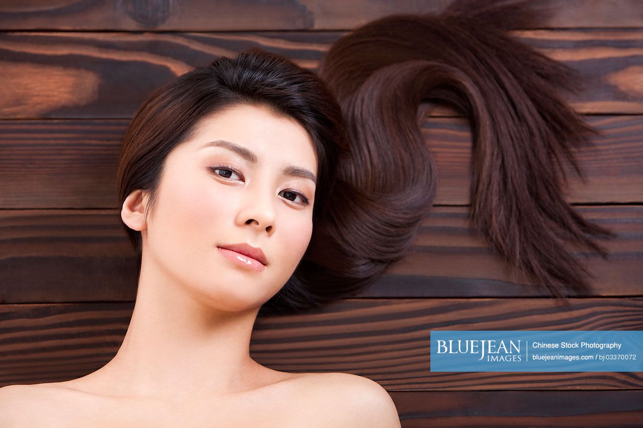 Charming young Chinese woman with silk-like hair-High-res stock photo for download