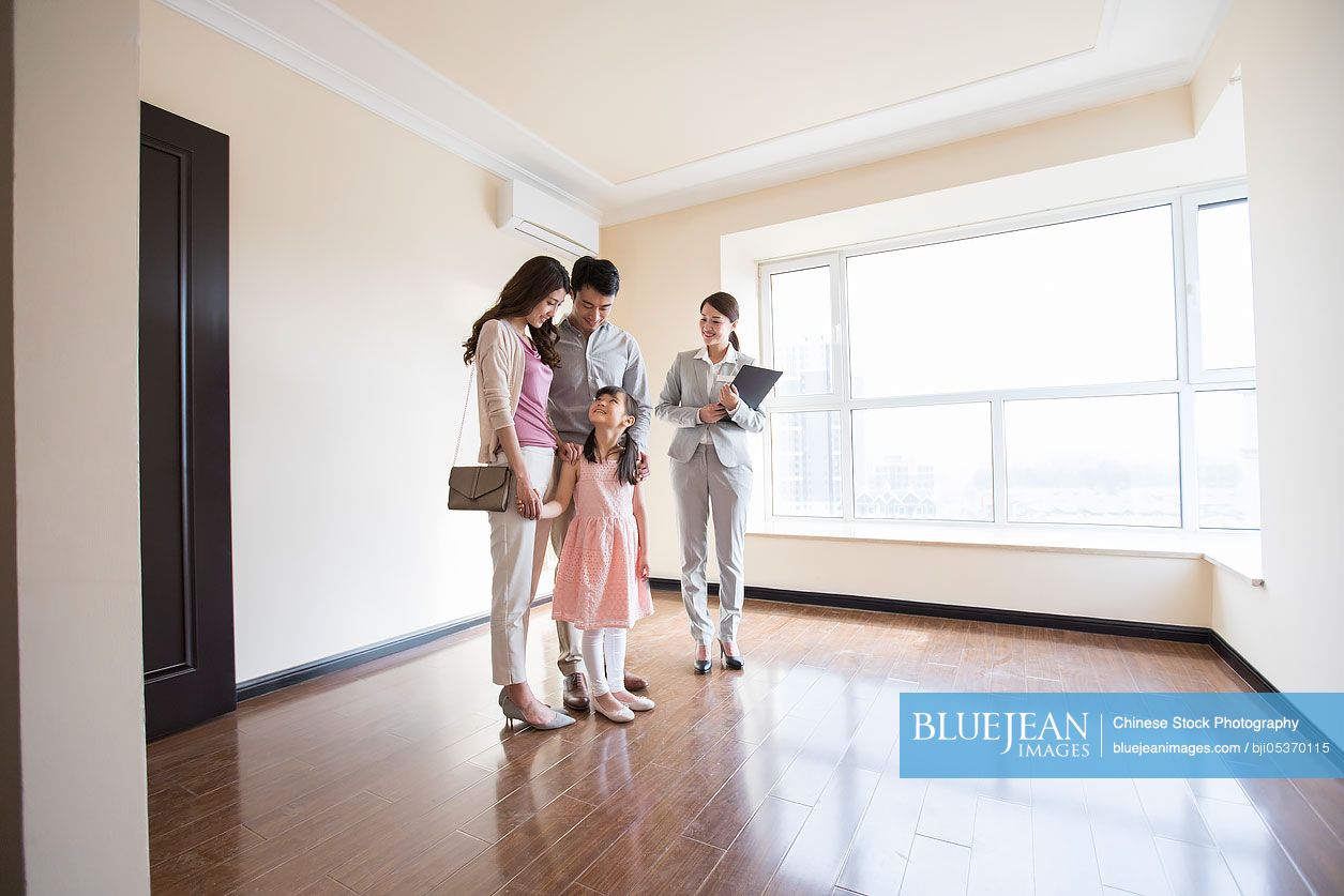 Chinese realtor showing new house to young family-High-res stock photo ...