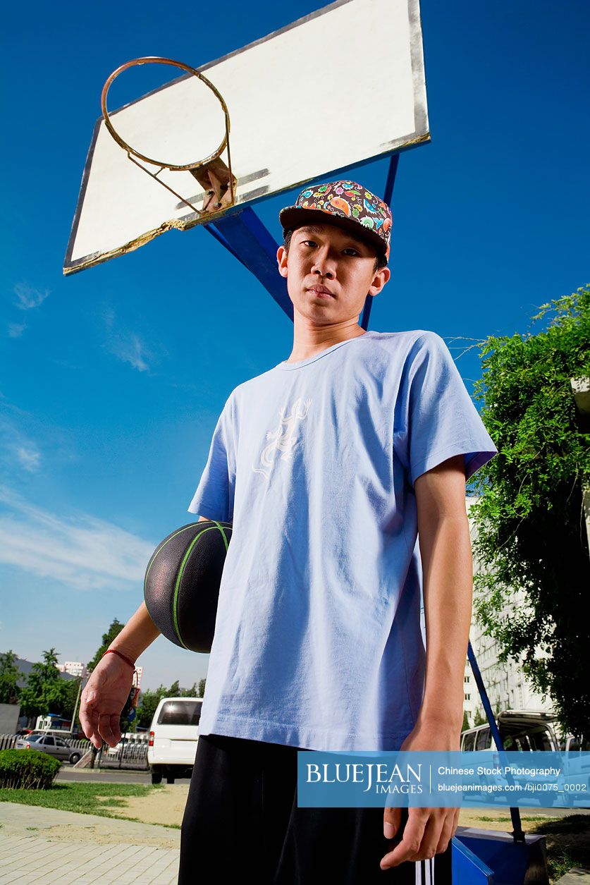 Chinese Teenage Boy With Basketball In Park-High-res stock photo for ...