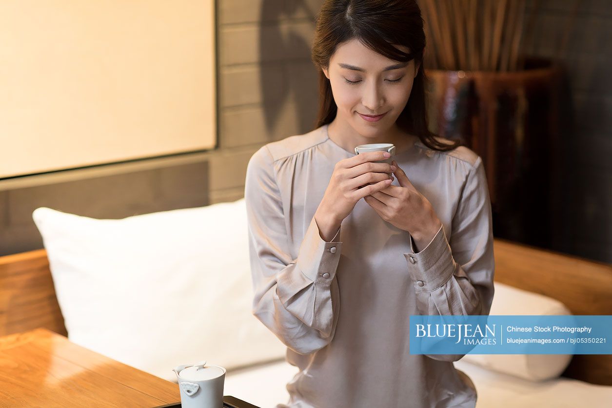 Young Chinese Woman Drinking Tea High res Stock Photo For Download