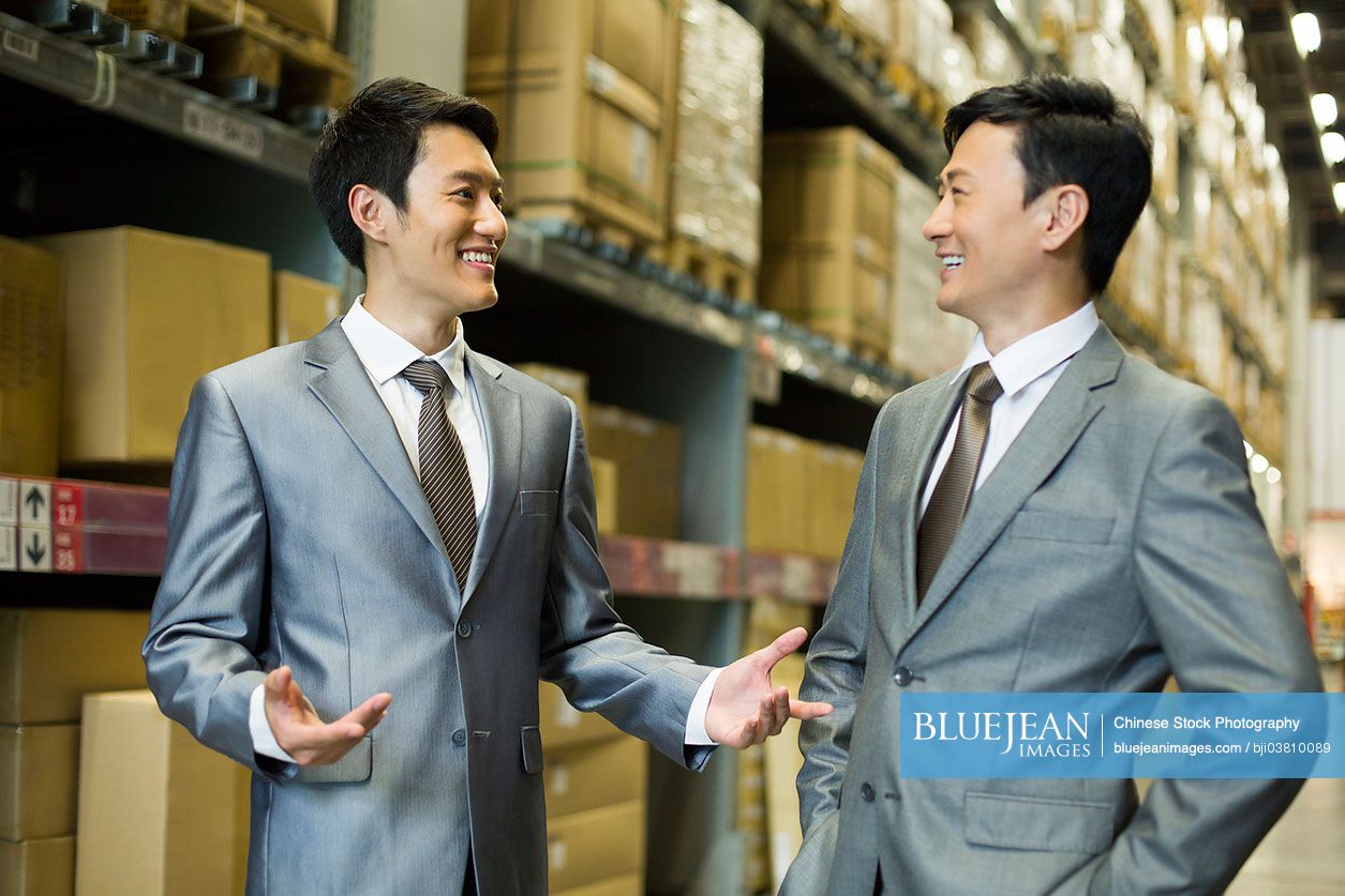 Chinese business partners talking in logistic warehouse-High-res stock ...