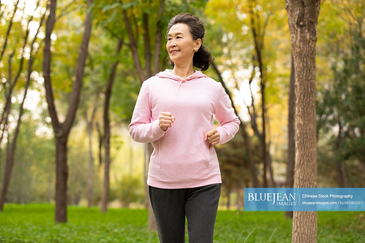 Happy senior Chinese woman running in the park-High-res stock photo for ...