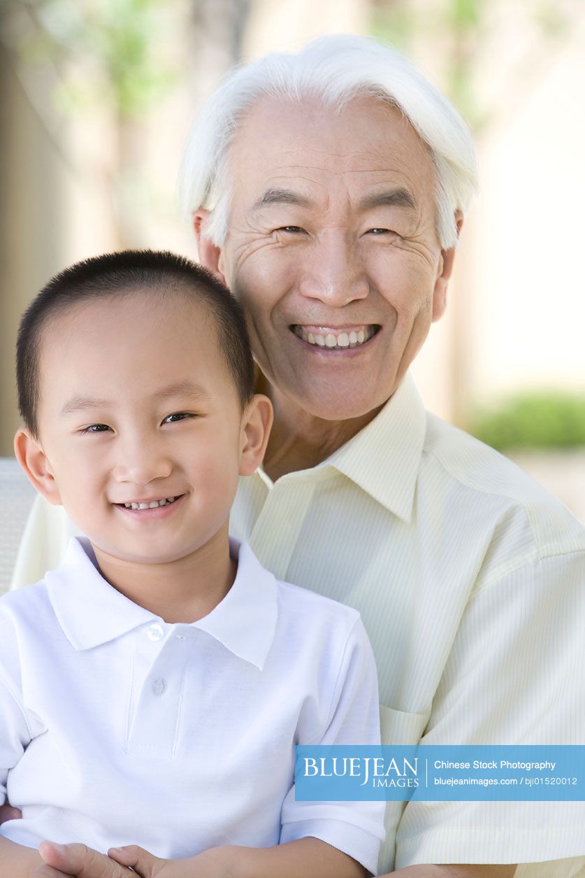 Chinese grandfather and grandson sitting in front of house-High-res ...
