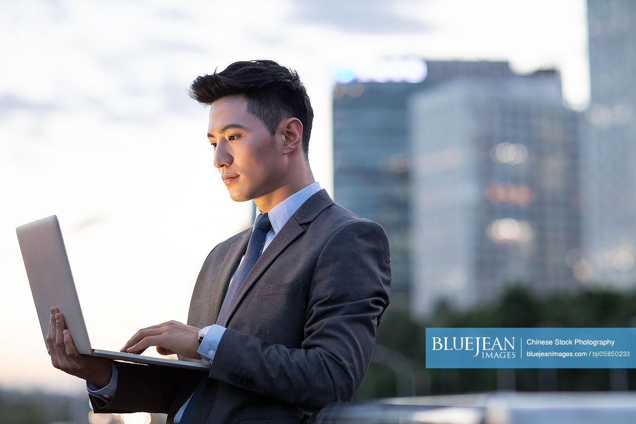 Young Chinese businessman using laptop-High-res stock photo for download