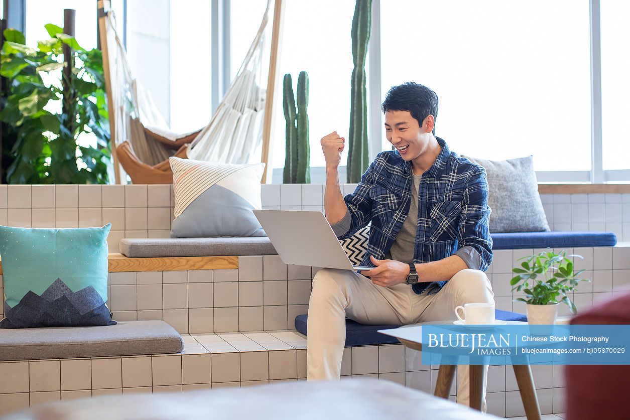 Young college student using laptop-High-res stock photo for download