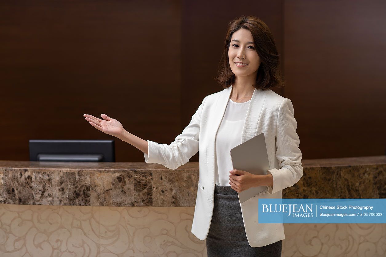 Chinese hotel manager in hotel lobby-High-res stock photo for download