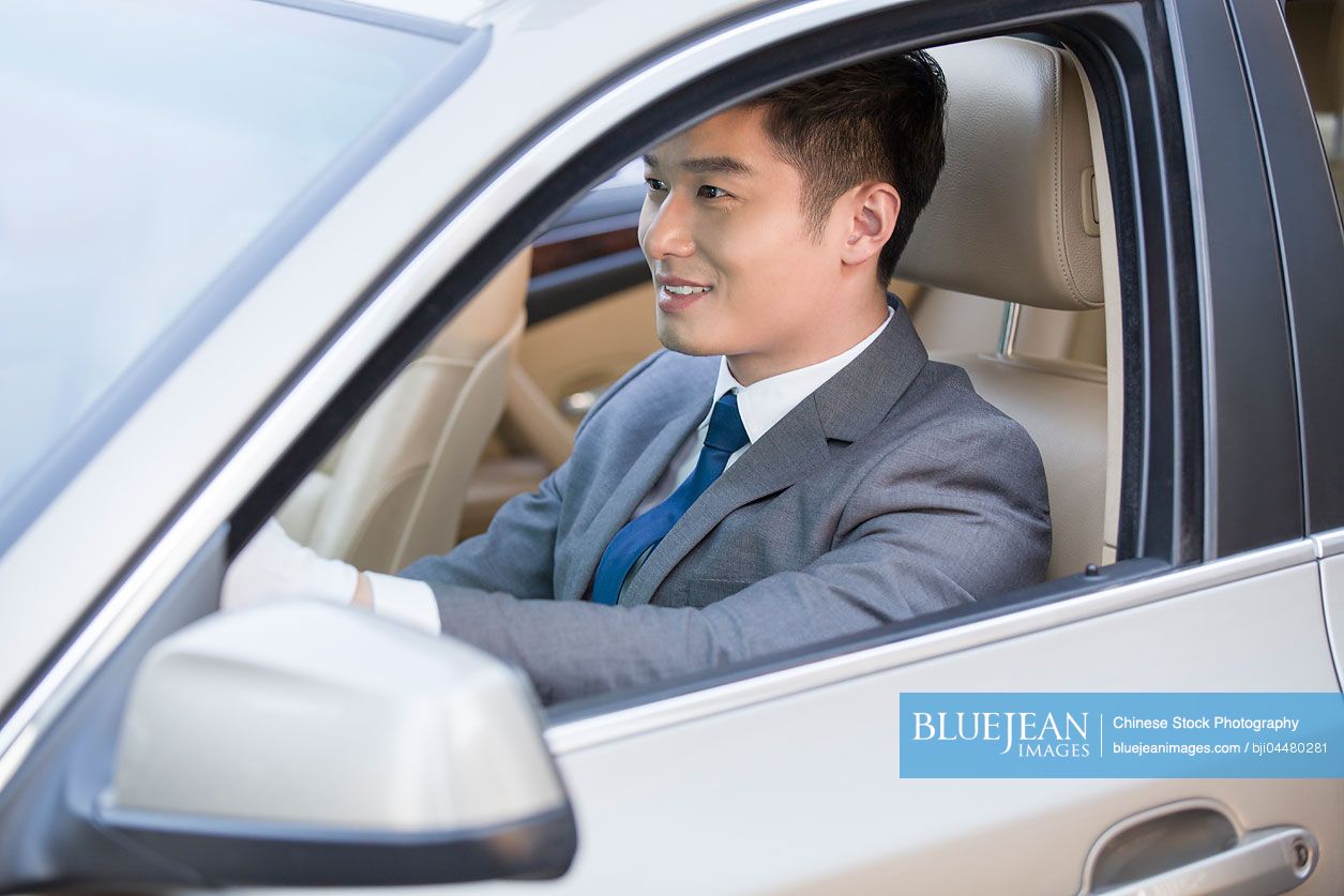 Chinese chauffeur driving car-High-res stock photo for download